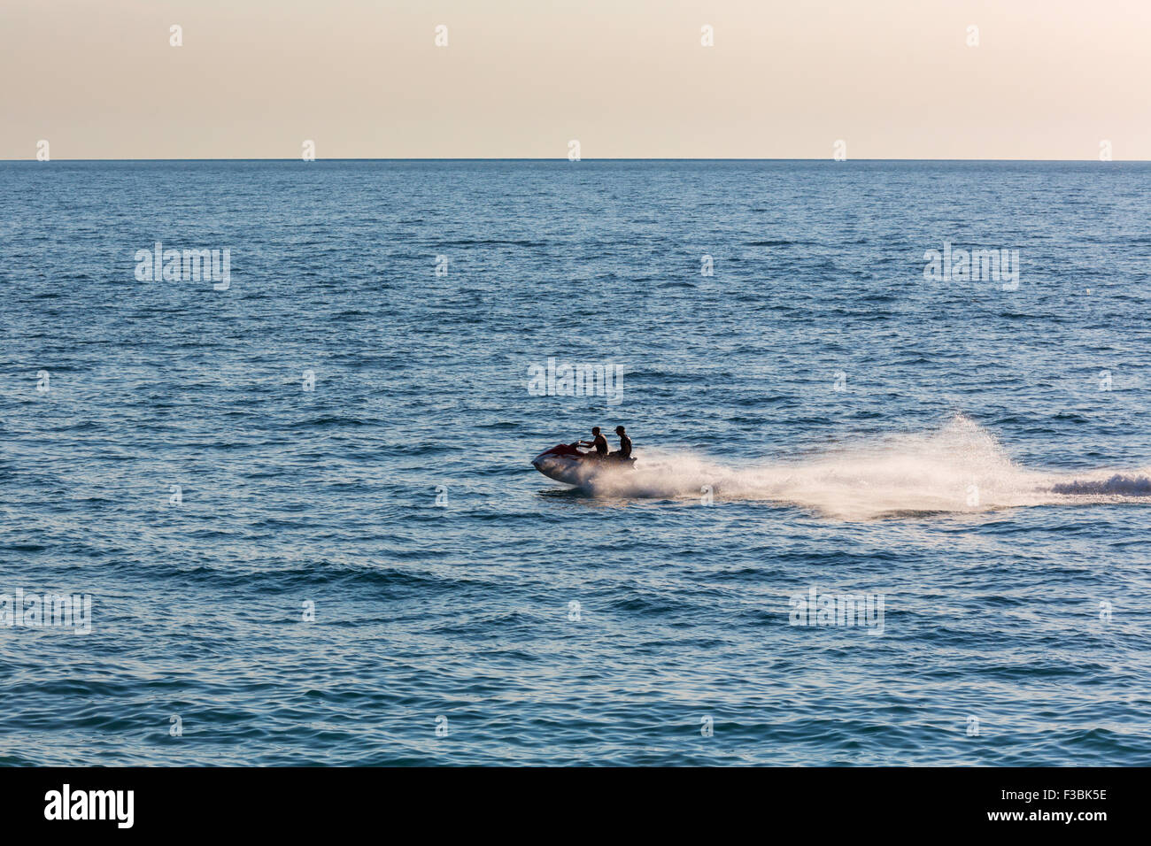 People riding jet ski on sea background Stock Photo - Alamy