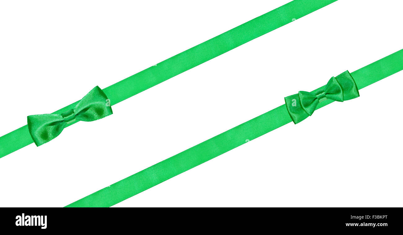 two little green bow knots on two diagonal satin ribbons isolated on ...