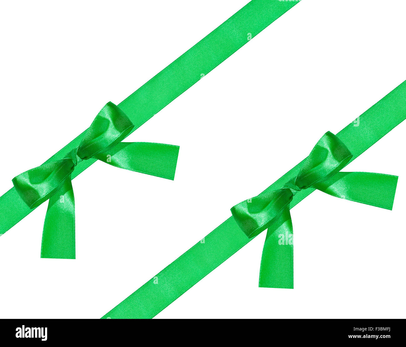 two big green bow knots on two diagonal satin bands isolated on white ...