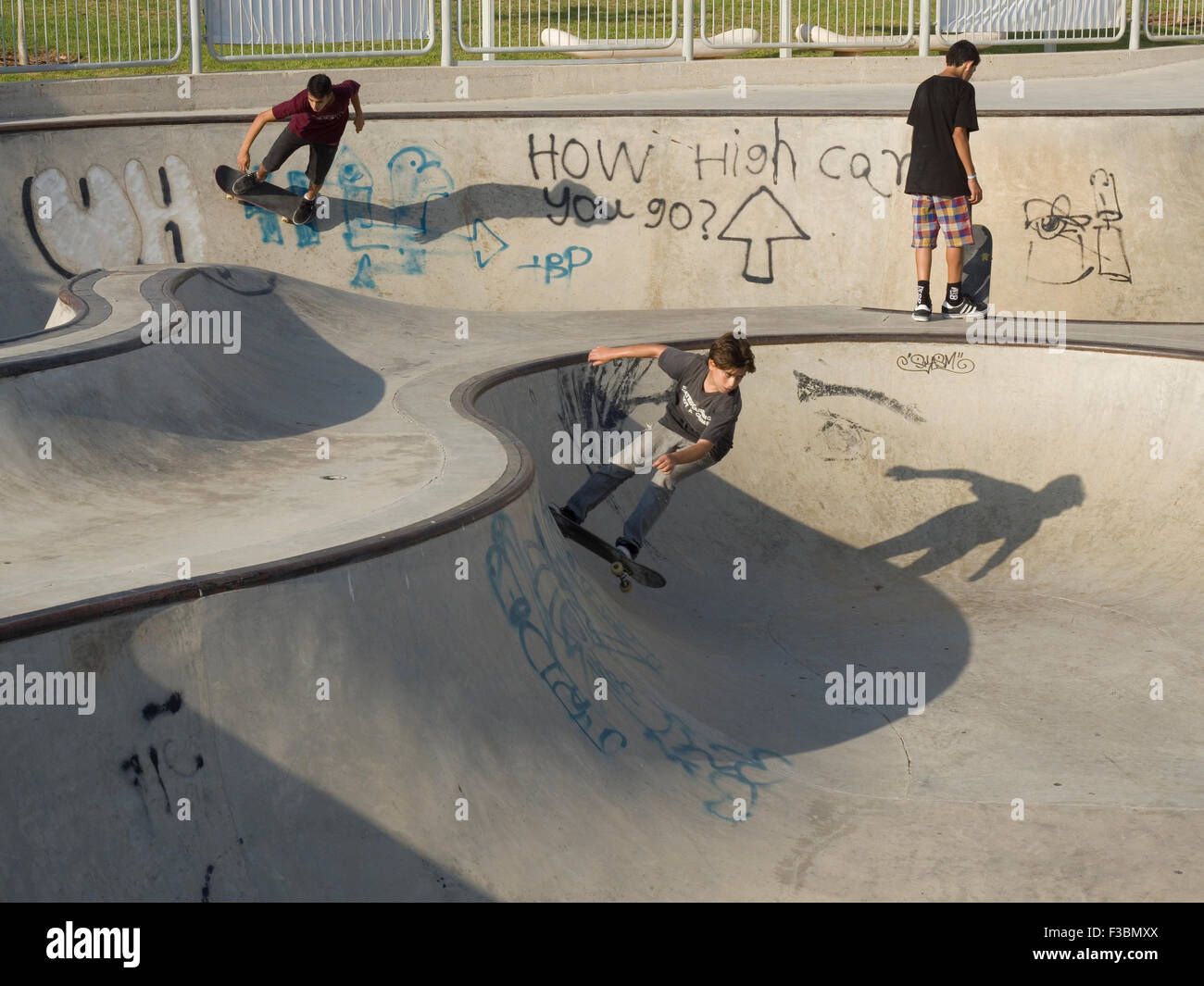 Urban extreme sport park. Young skateboarder performs stunts with a ...