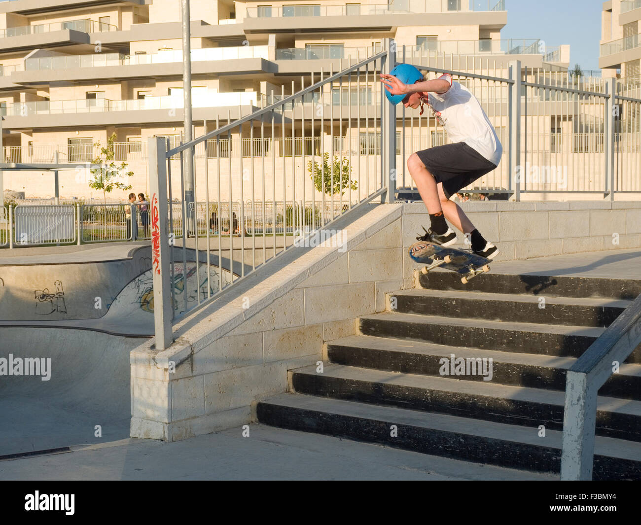 Urban extreme sport park. Young skateboarder performs stunts with a ...