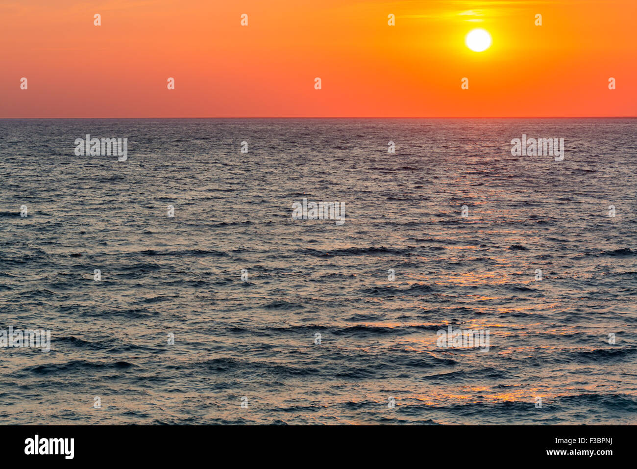 Colorful sunset over the sea with golden sky Stock Photo - Alamy
