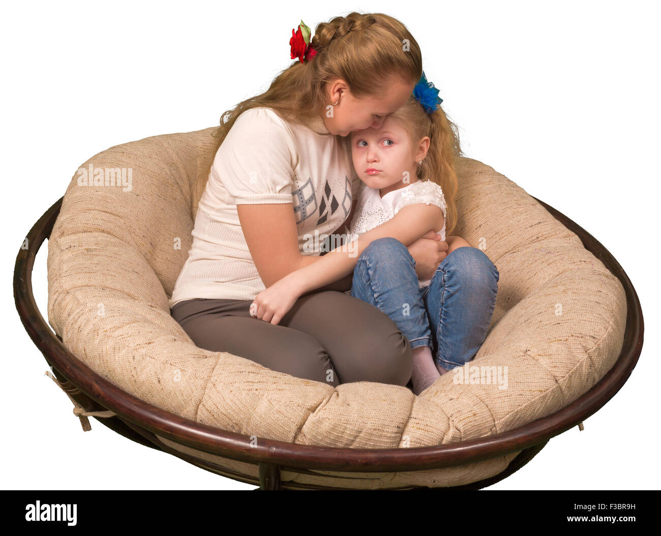 Elder sister consoles the younger two girls together Stock Photo - Alamy