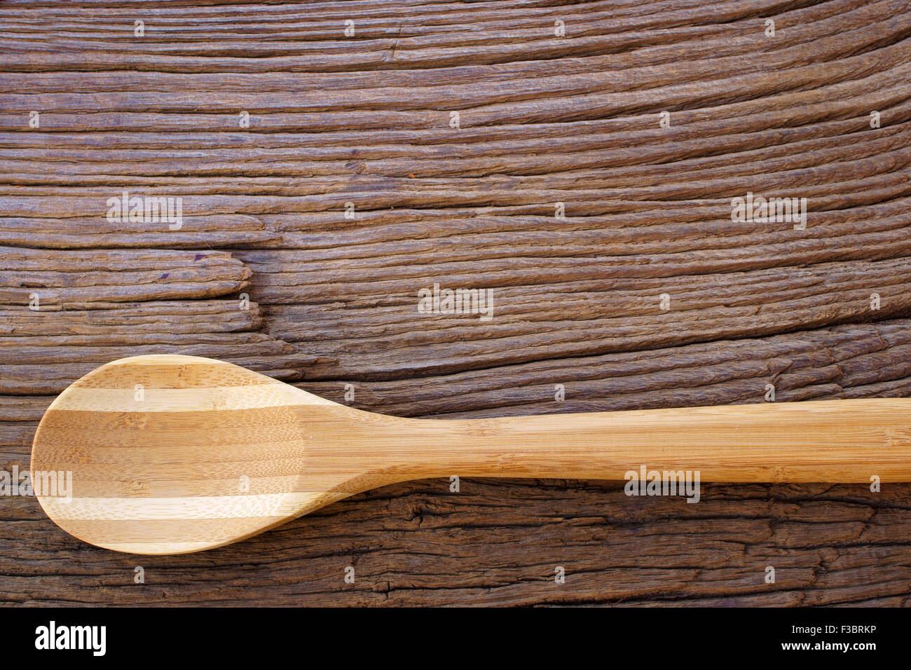 Wooden cooking Spoon on a rustic wooden background with copy space as ...