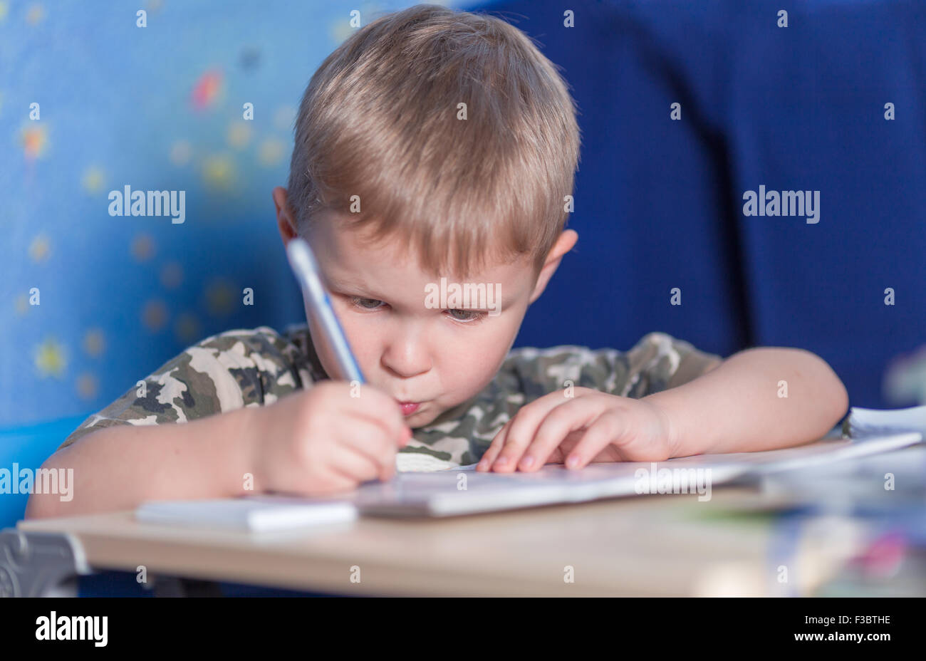 Preschool boy learning to write education writing Stock Photo - Alamy