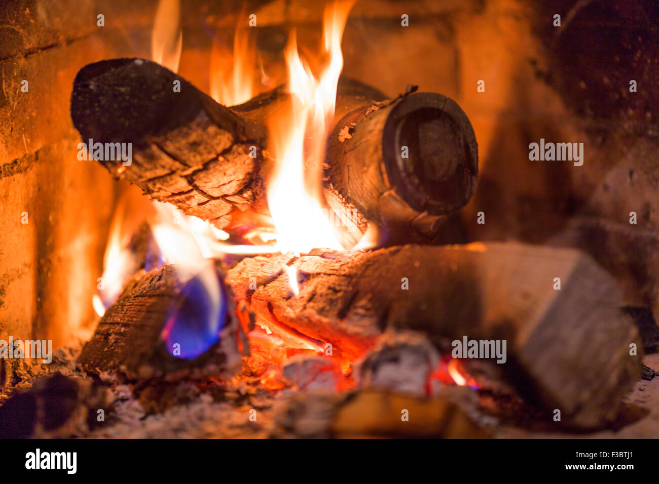 Firewood burning in fireplace fire flame red ashes Stock Photo - Alamy