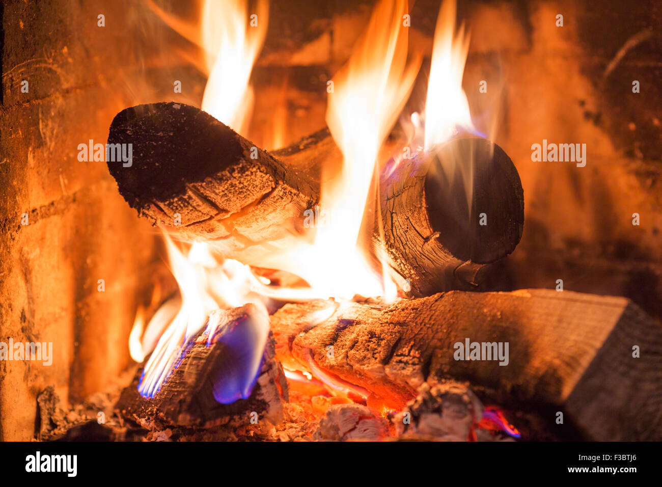 Firewood burning fireplace fire flame heat red ashes Stock Photo - Alamy
