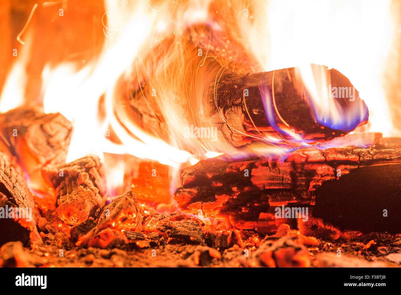 Firewood burning in fireplace fire flame red ashes Stock Photo - Alamy