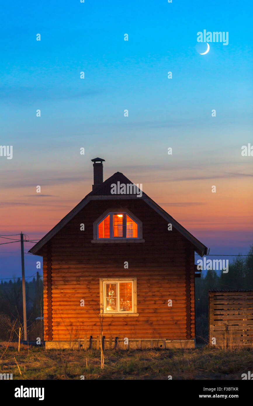 wooden house exterior with lights night view Stock Photo - Alamy
