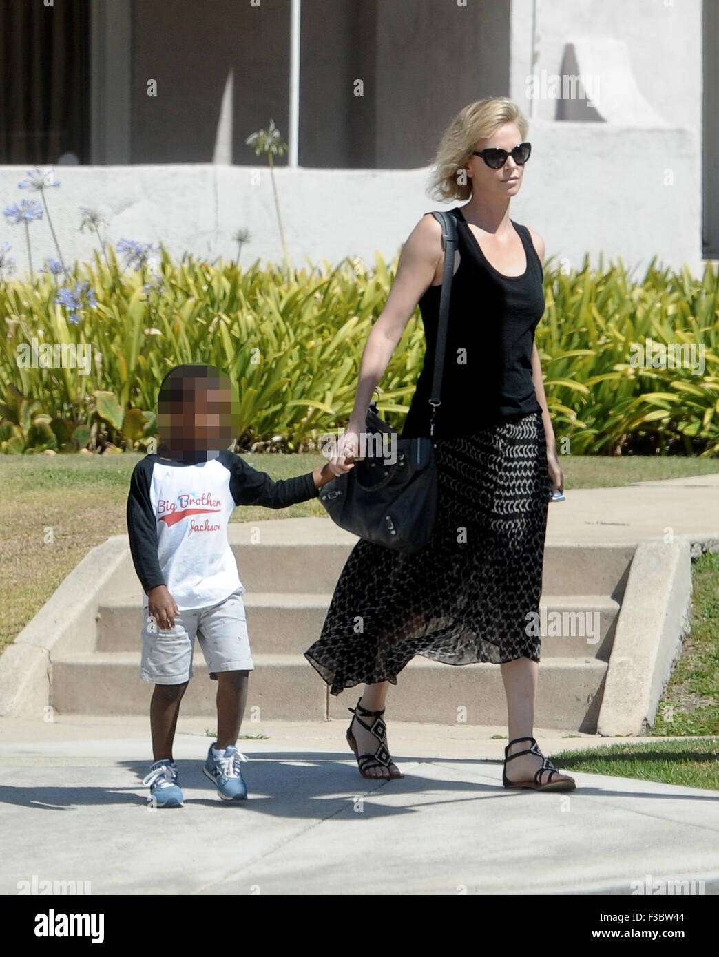 Actress Charlize Theron heads to a friends in Los Angeles house with ...