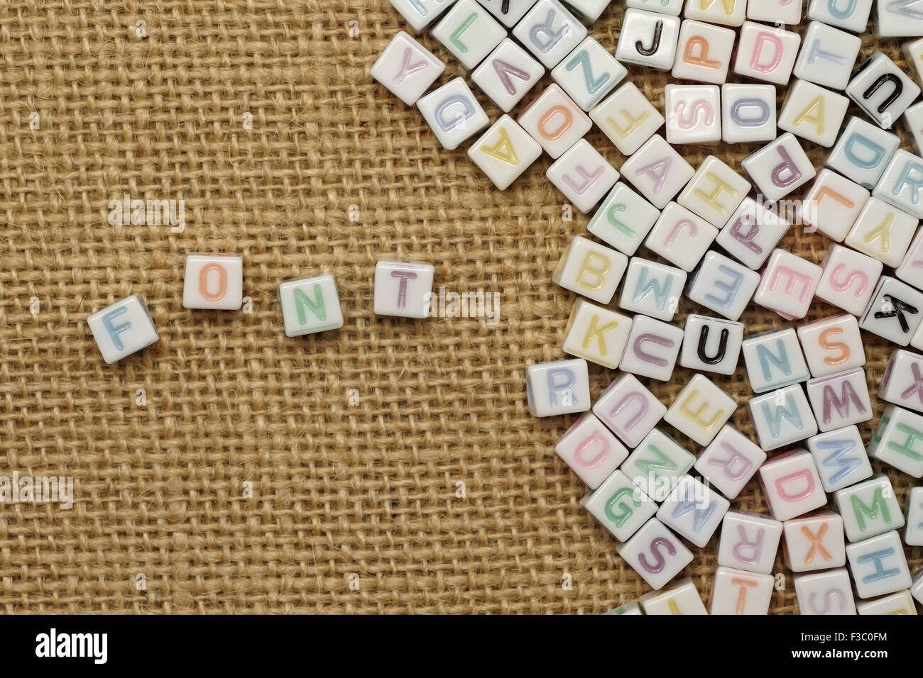 colorful word font on burlap fabric background Stock Photo - Alamy