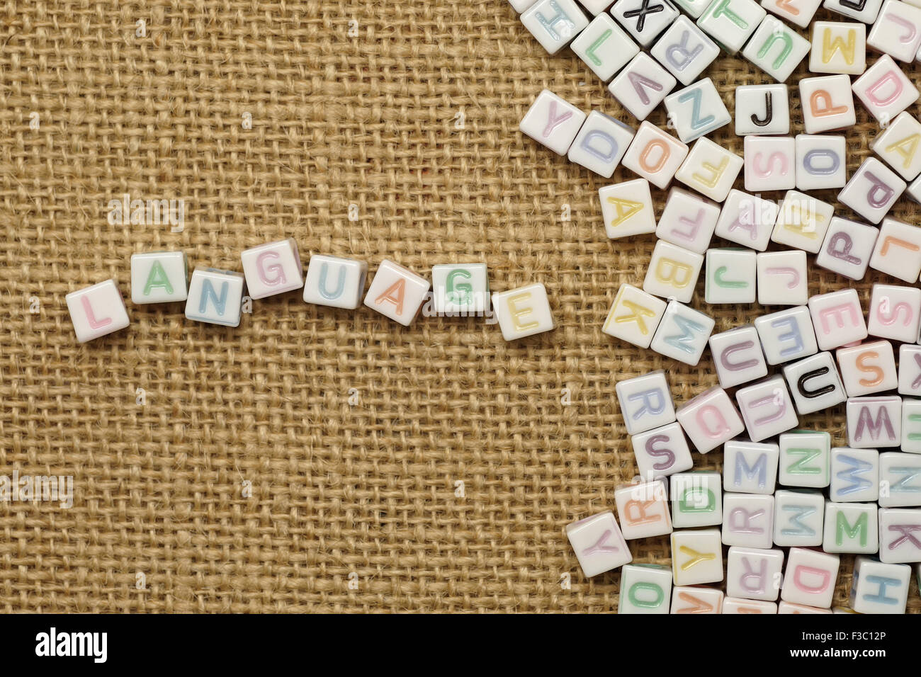 colorful word language on burlap fabric background Stock Photo - Alamy