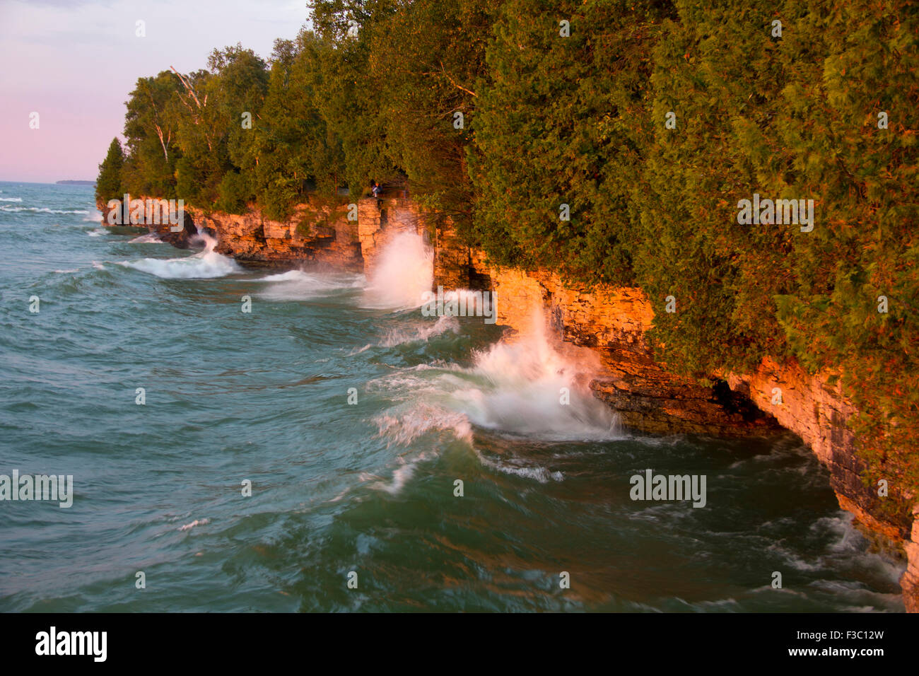 Rugged limestone ledges rise 20-40 feet above Lake Michigan, Cave Point ...