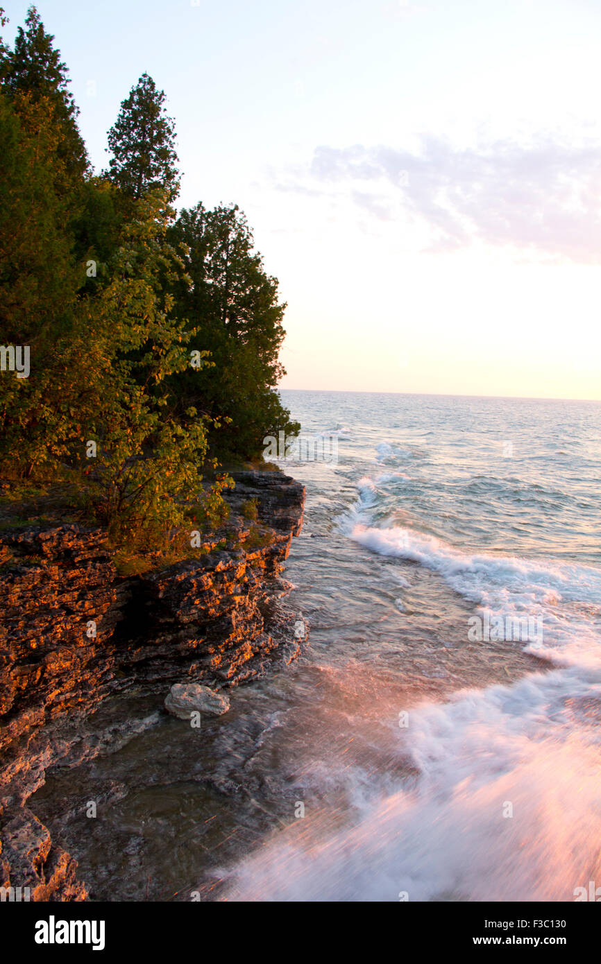Rugged limestone ledges rise 20-40 feet above Lake Michigan, Cave Point ...