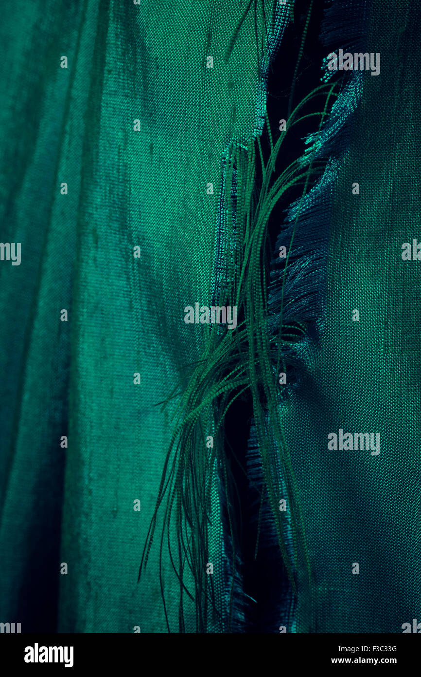 A piece of turquoise colored ripped silk fabric Stock Photo - Alamy