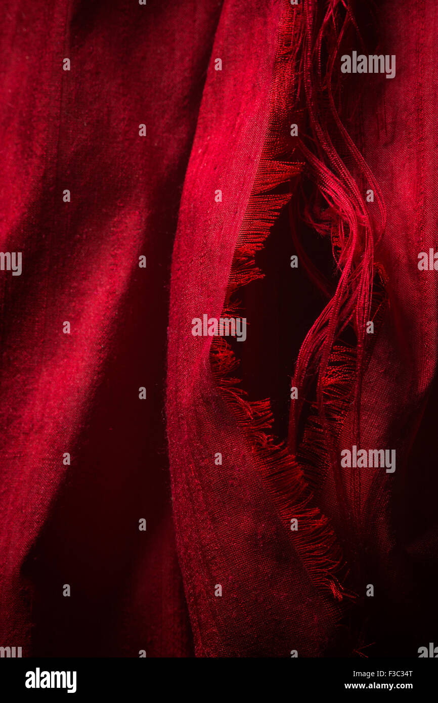 A piece of ripped red silk fabric Stock Photo - Alamy