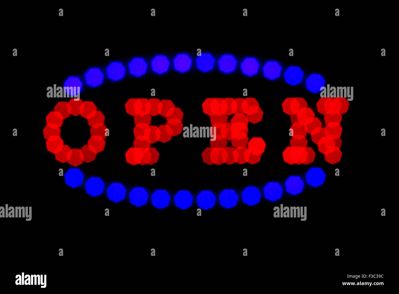 blurry red and blue neon signboard with word open on back blackground ...