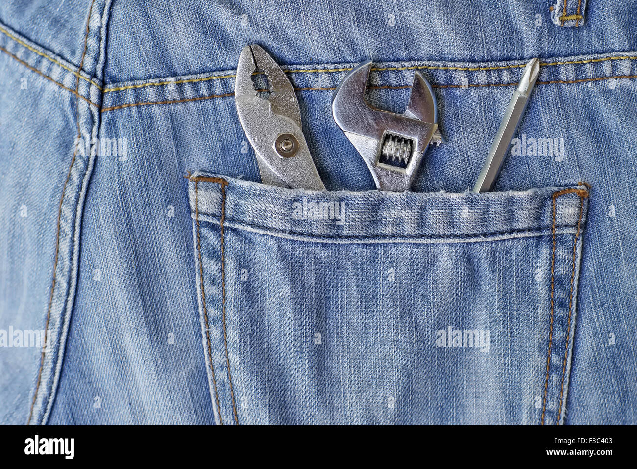 several tools in denim workers pocket jeans Stock Photo - Alamy