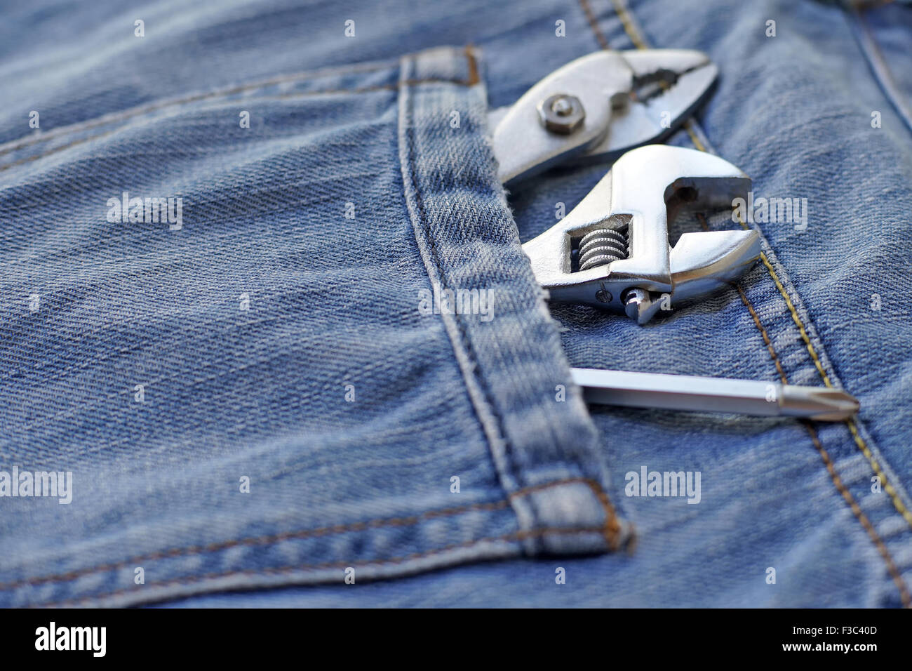 several tools in denim workers pocket jeans Stock Photo - Alamy