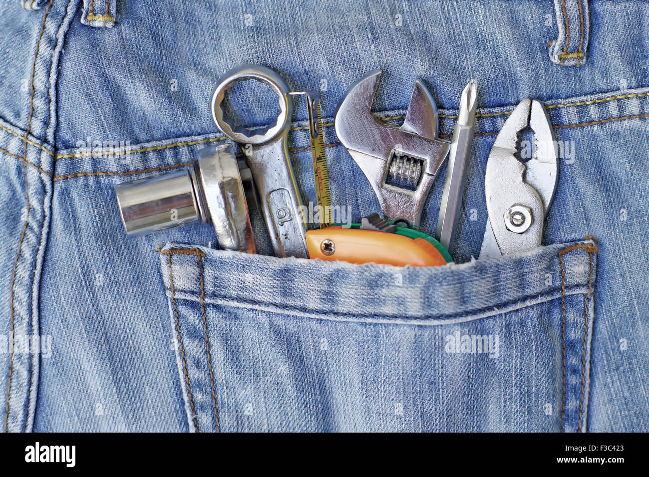 several tools in denim workers pocket jeans Stock Photo - Alamy