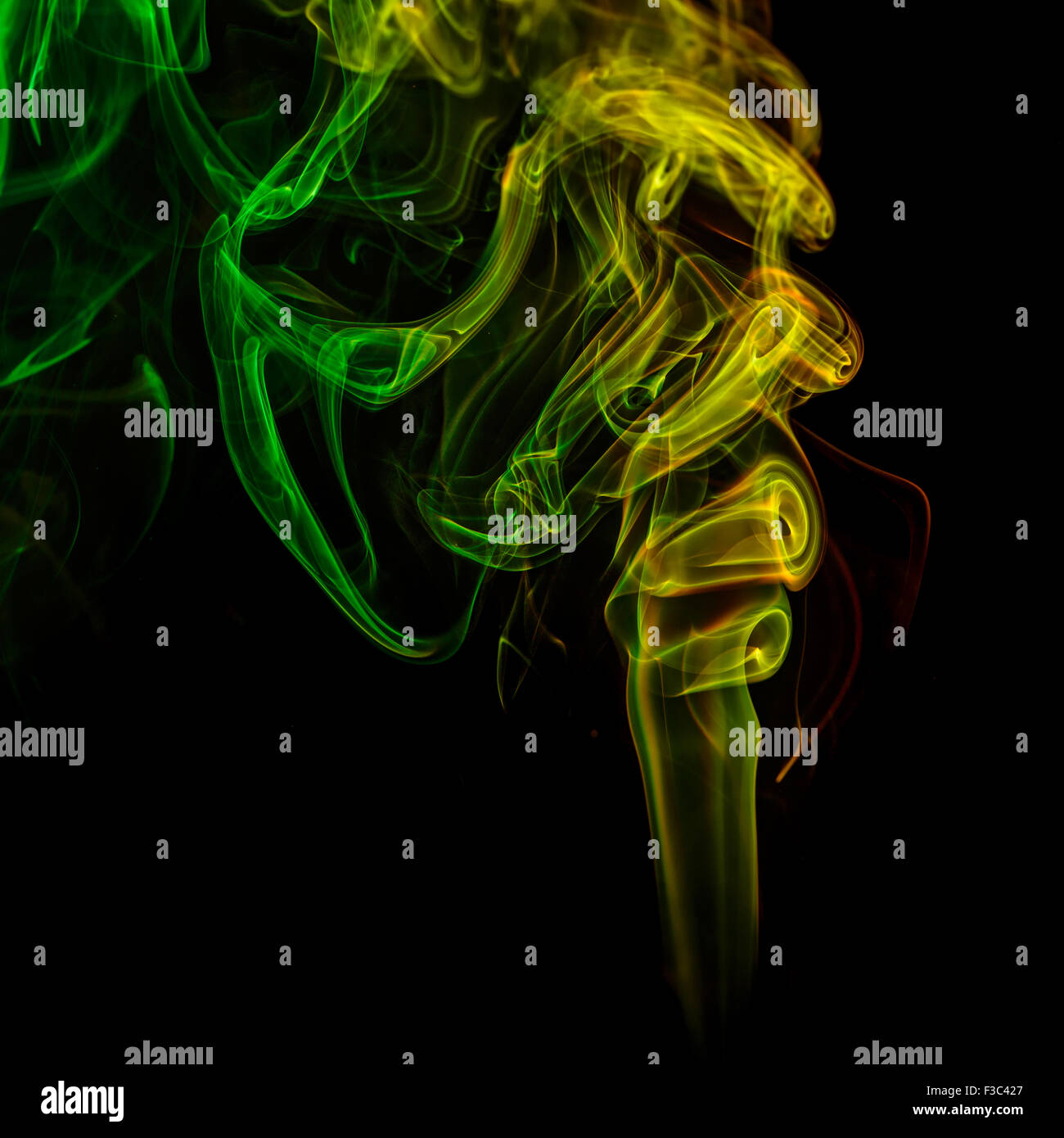 Abstract art. Color yellow-green smoke from the aromatic sticks on a ...
