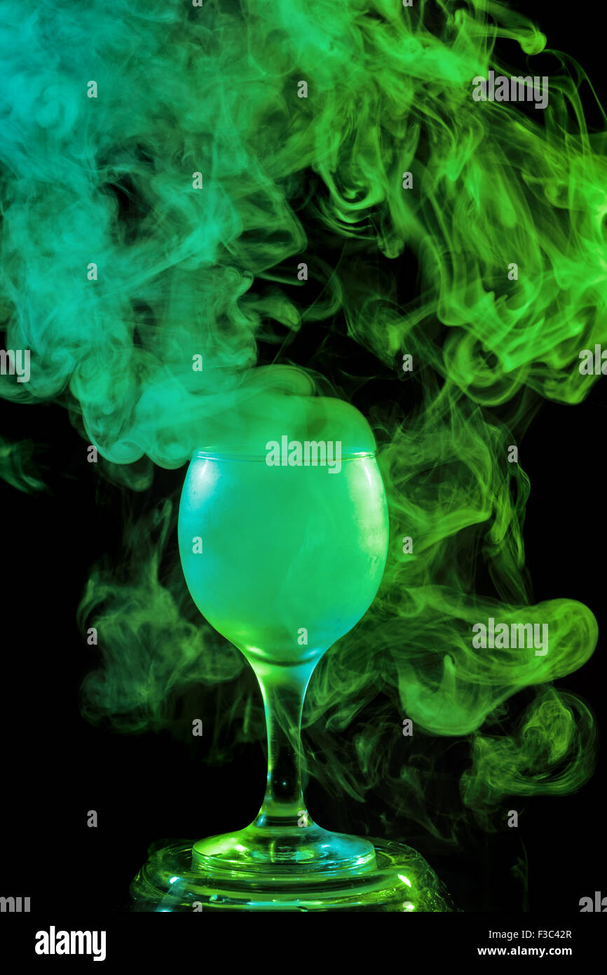 Abstract art. Hookah green smoke in cocktail glass on a white ...
