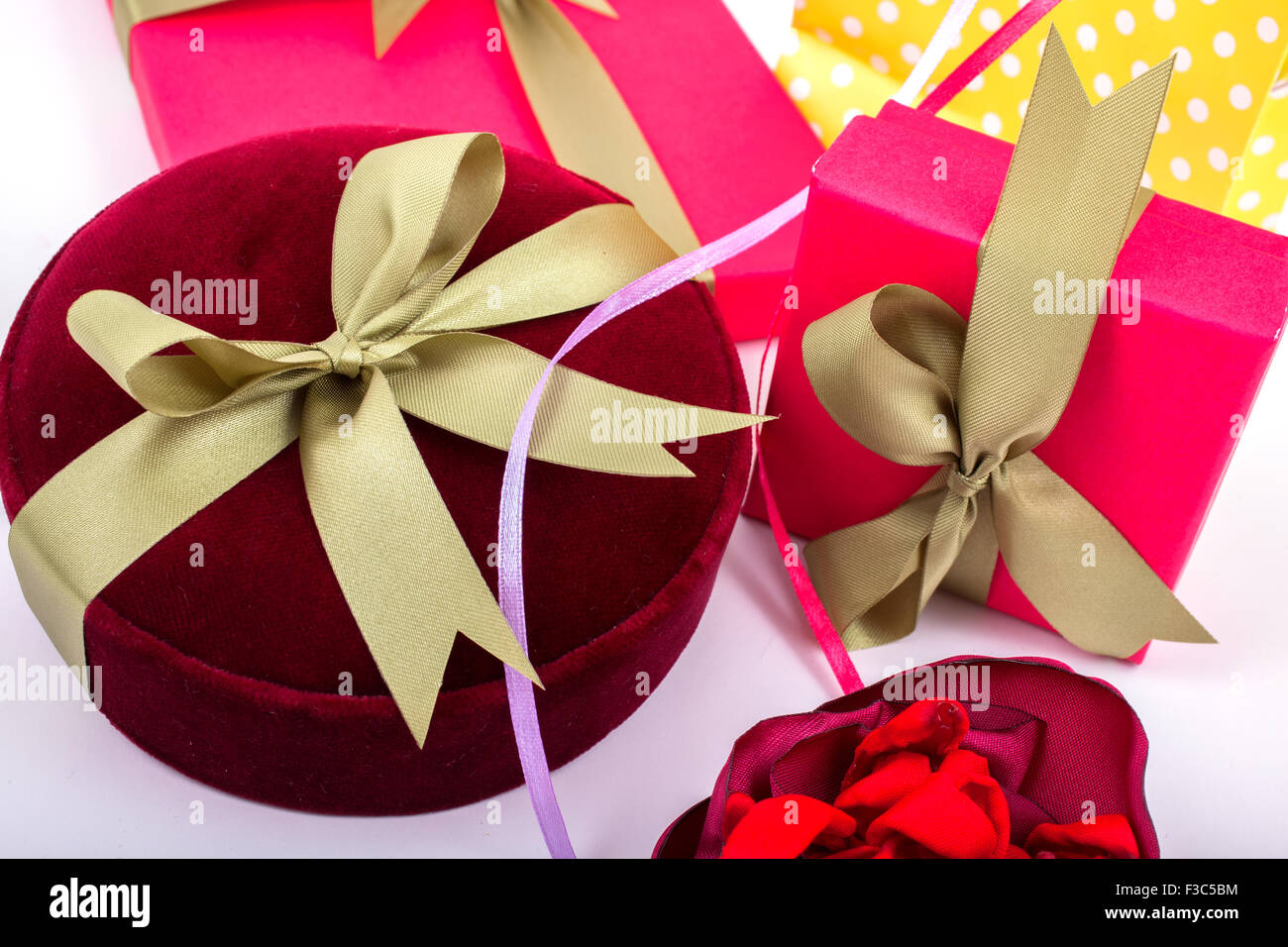 Luxury gift boxes in dark red and brown shades with green satin ribbon ...