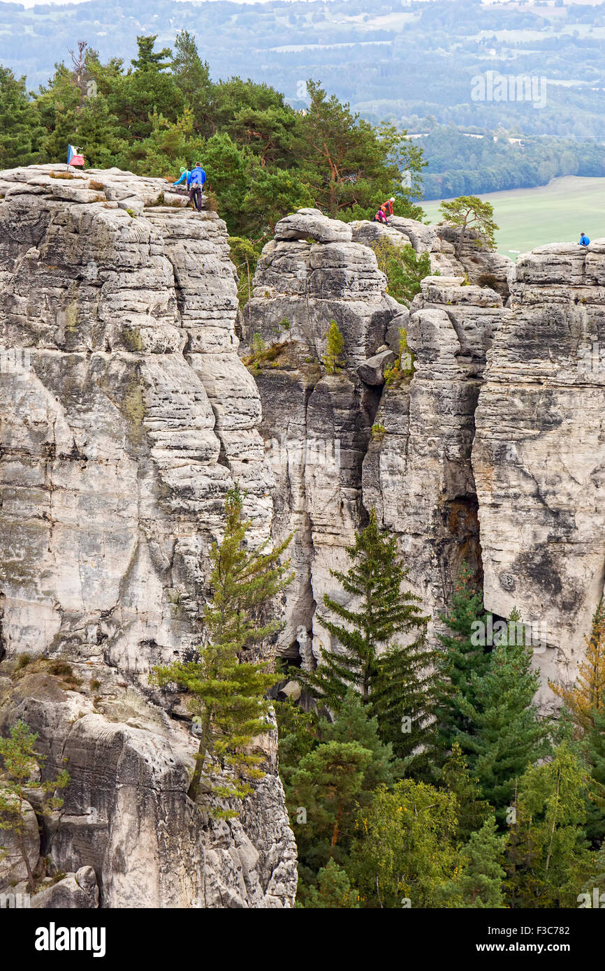 Cliffs, rocky towers with mountain climbers in area called Cesky Raj ...