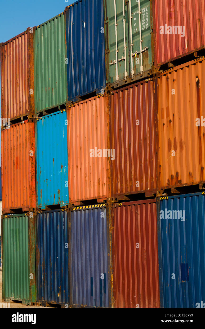 Stacked color cargo containers under the blue sky Stock Photo - Alamy