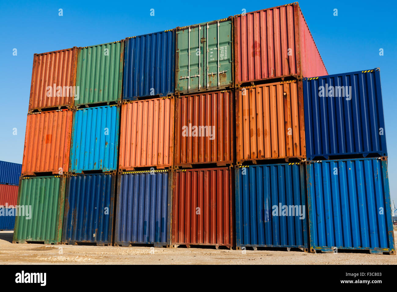 Stacked color cargo containers under the blue sky Stock Photo - Alamy