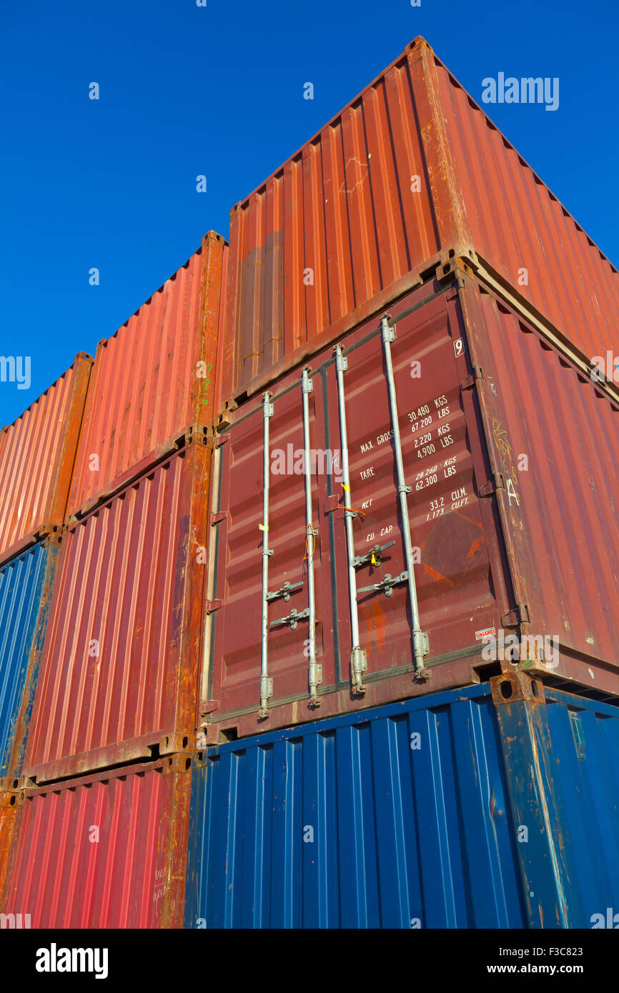 Stacked color cargo containers under the blue sky Stock Photo - Alamy