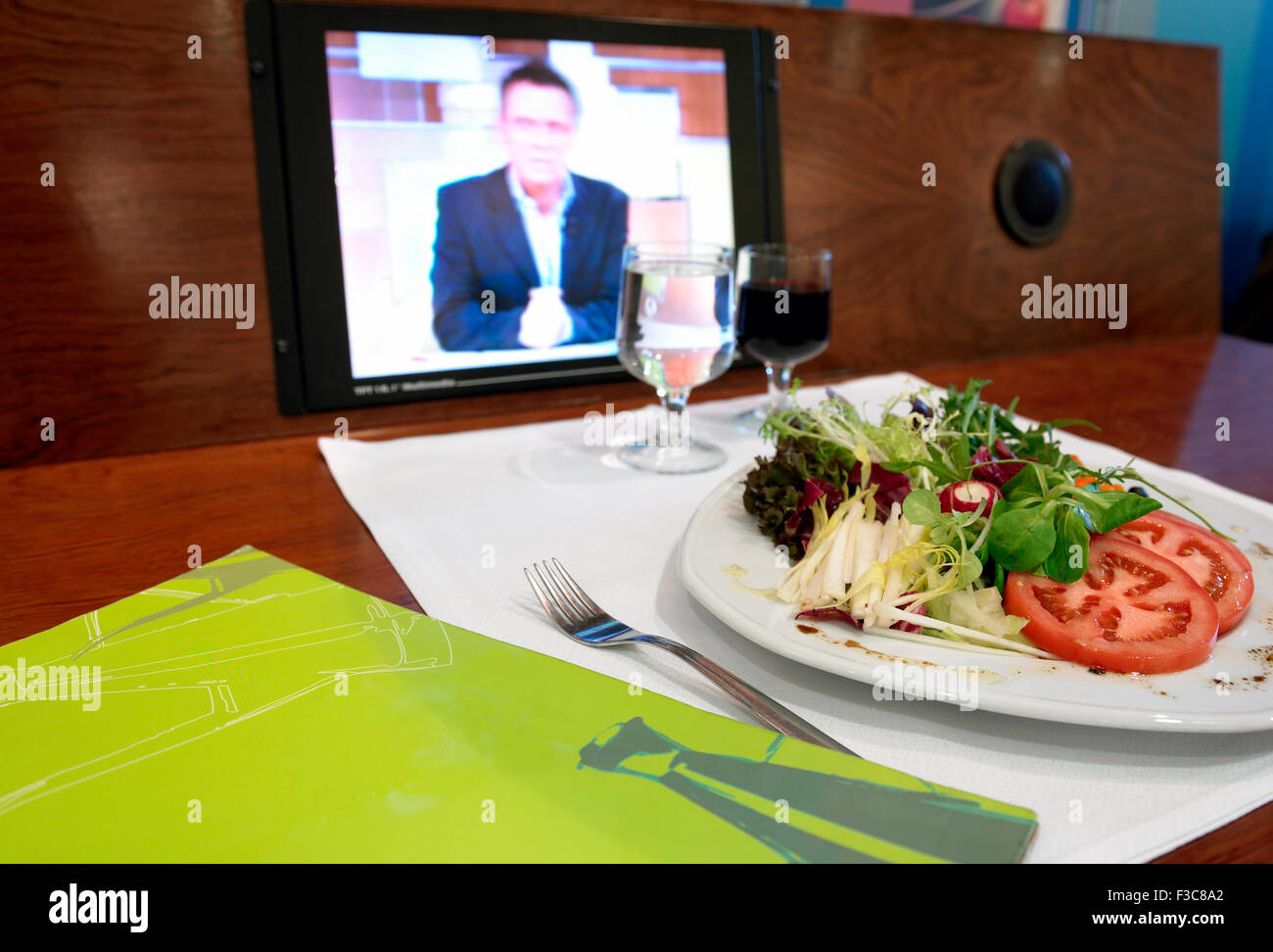 Lunch break for one person healthy food while watching TV at Restaurant ...