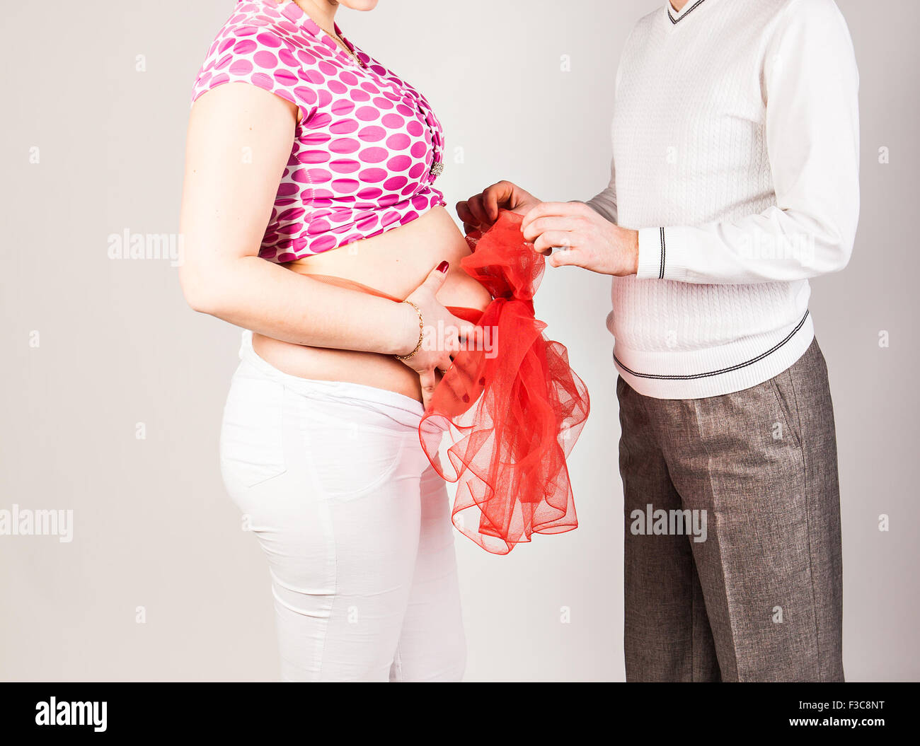 Male Hand Touching Pregnant Woman Belly On White Background Stock