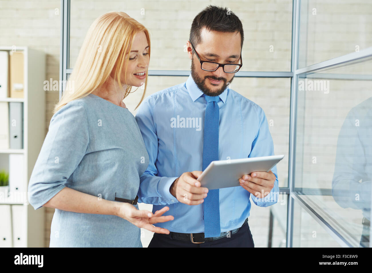 Two confident colleagues networking in office Stock Photo - Alamy