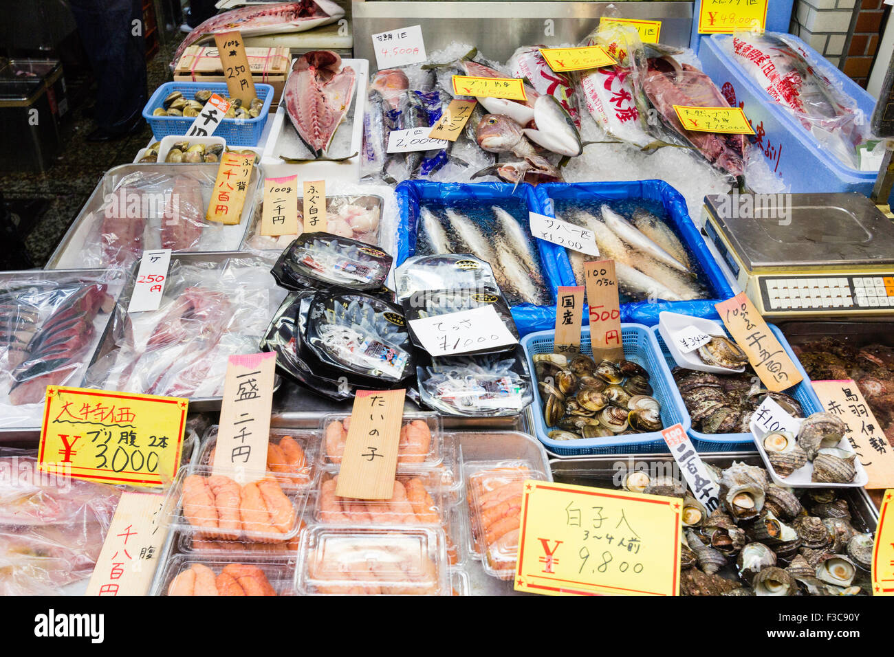 Trays of fishfood on display on stall at Kuromon Ichiba food market in ...