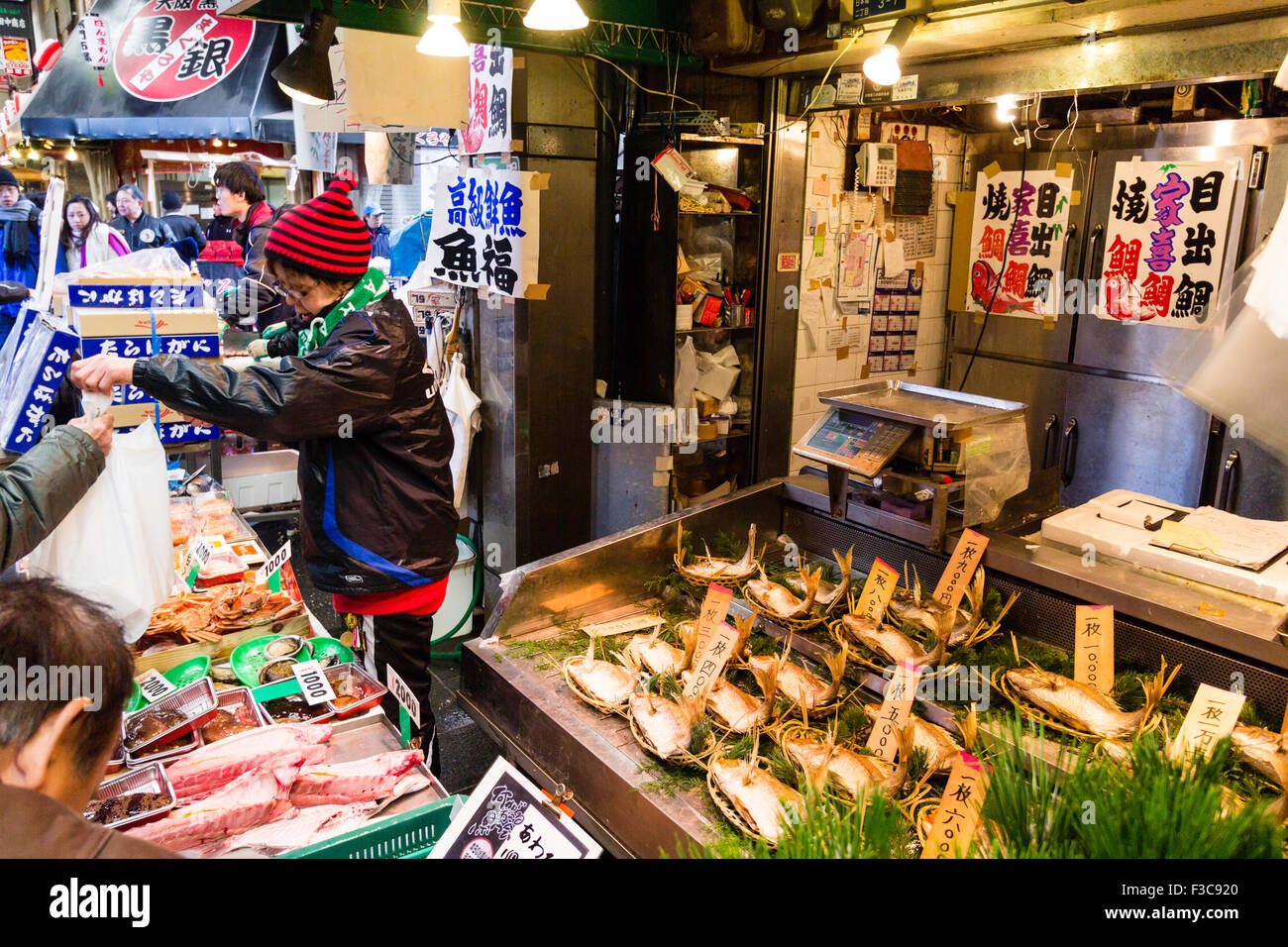 Kuromon market in Osaka. Fish stall selling freshly caught fish to ...