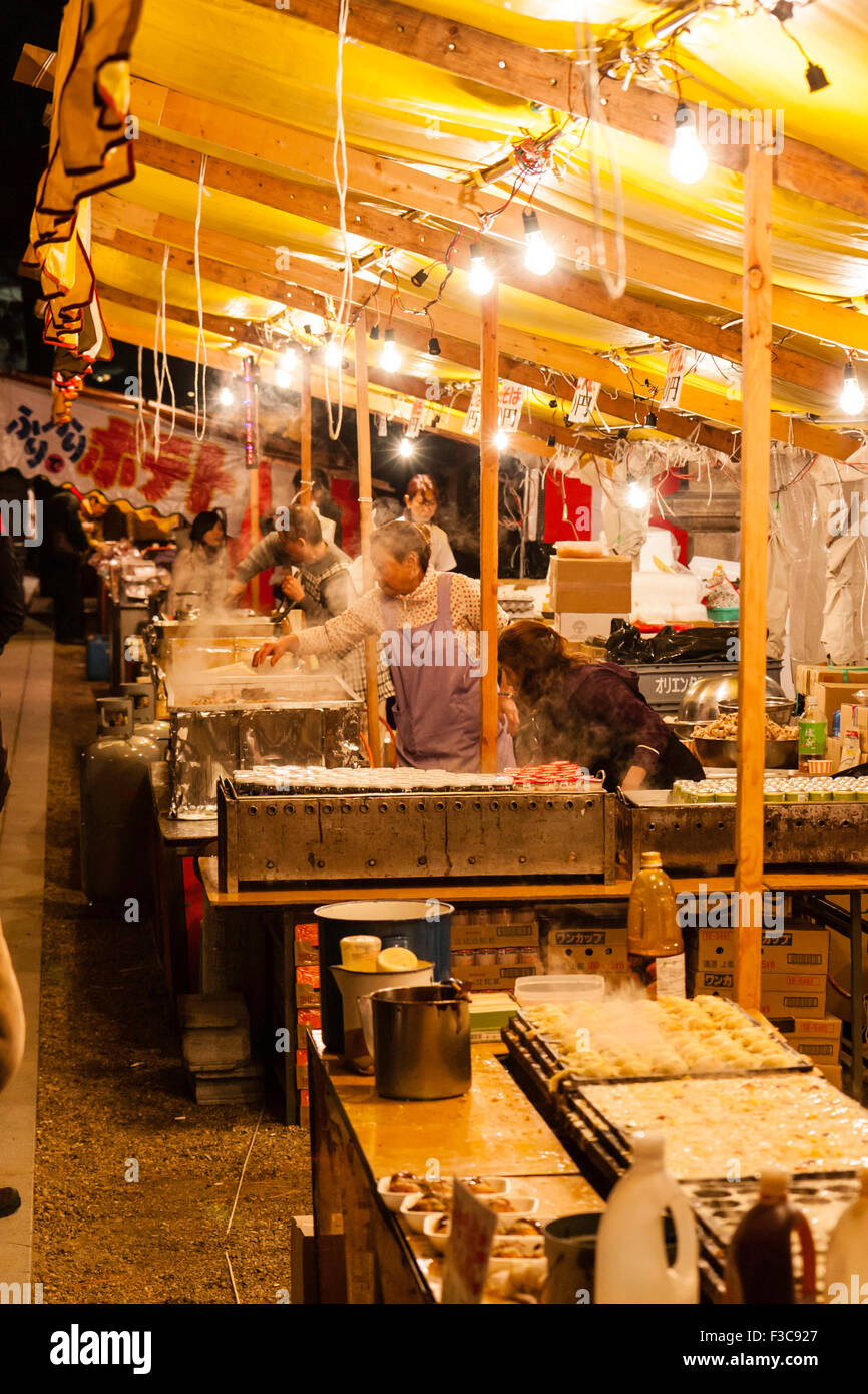 View along row of traditional Japanese fast food stalls preparing at ...