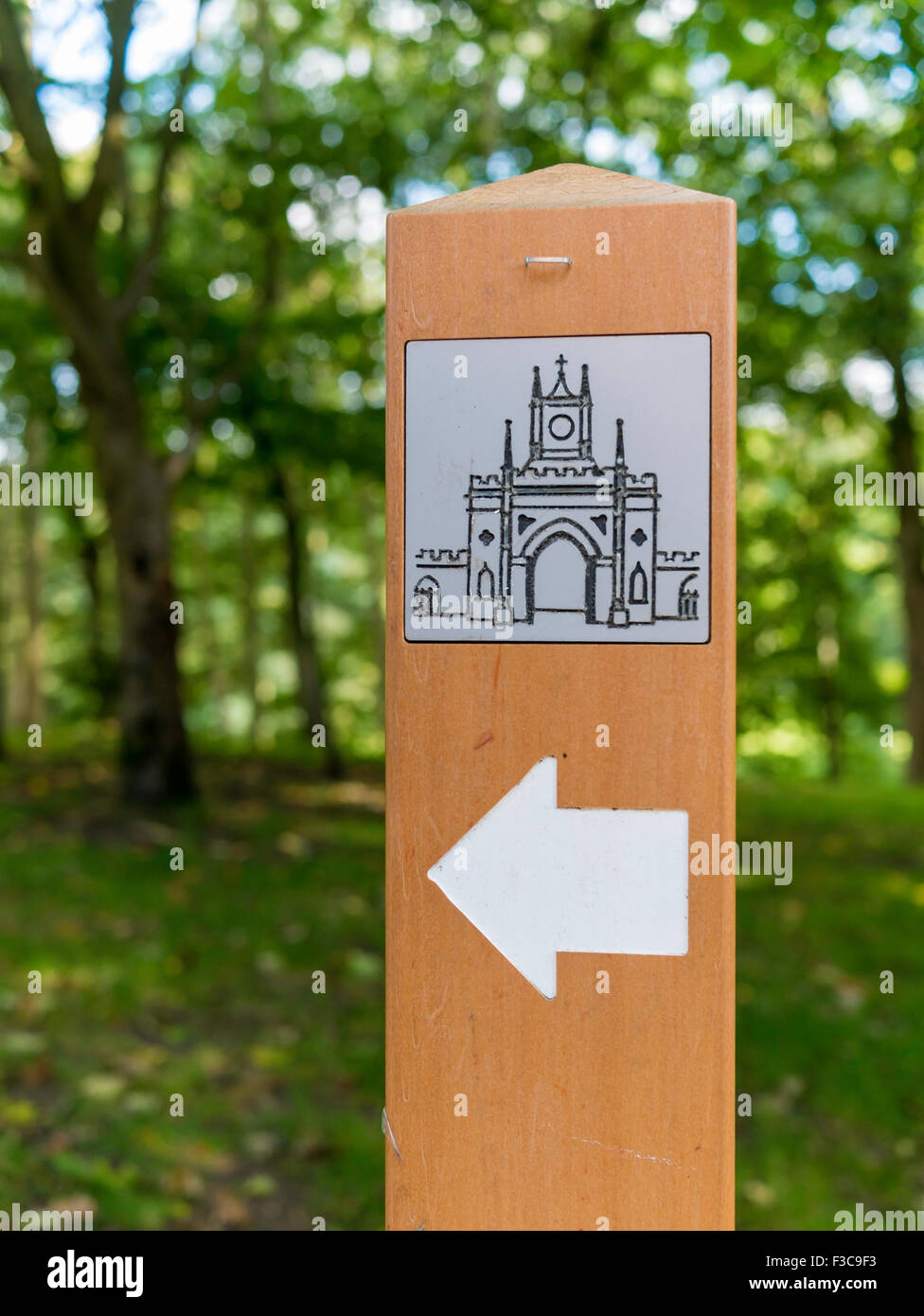 Wooden marker post, showing the castle gate on a path in the Deer Park ...