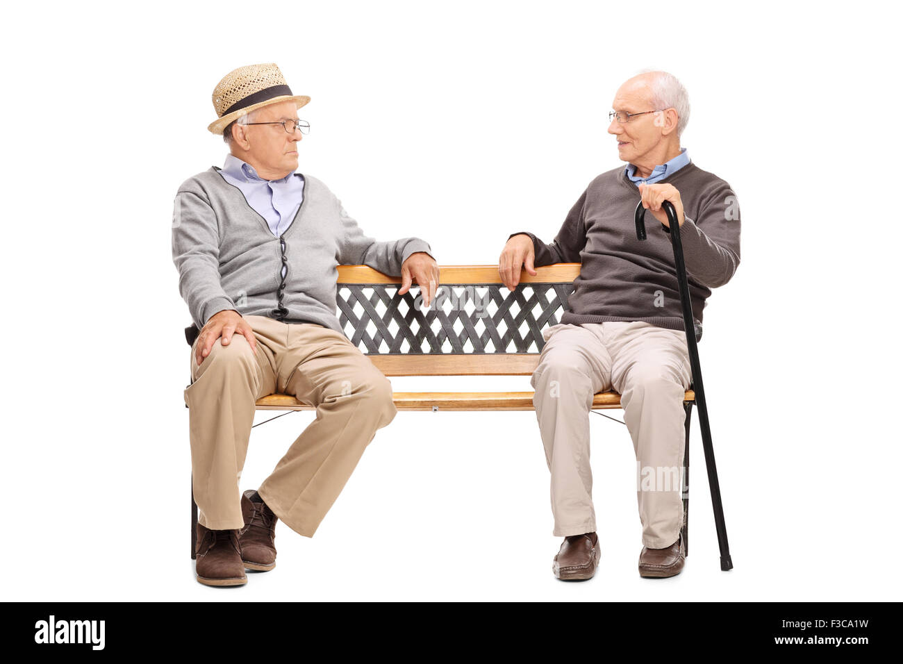Studio shot of a two senior men arguing with each other seated on a ...