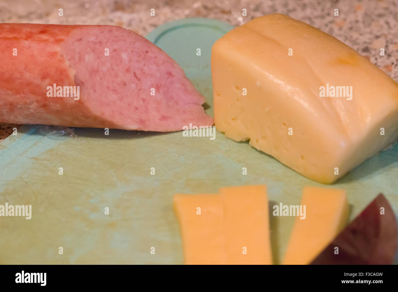 the cut sausage and cheese on a chopping board Stock Photo - Alamy