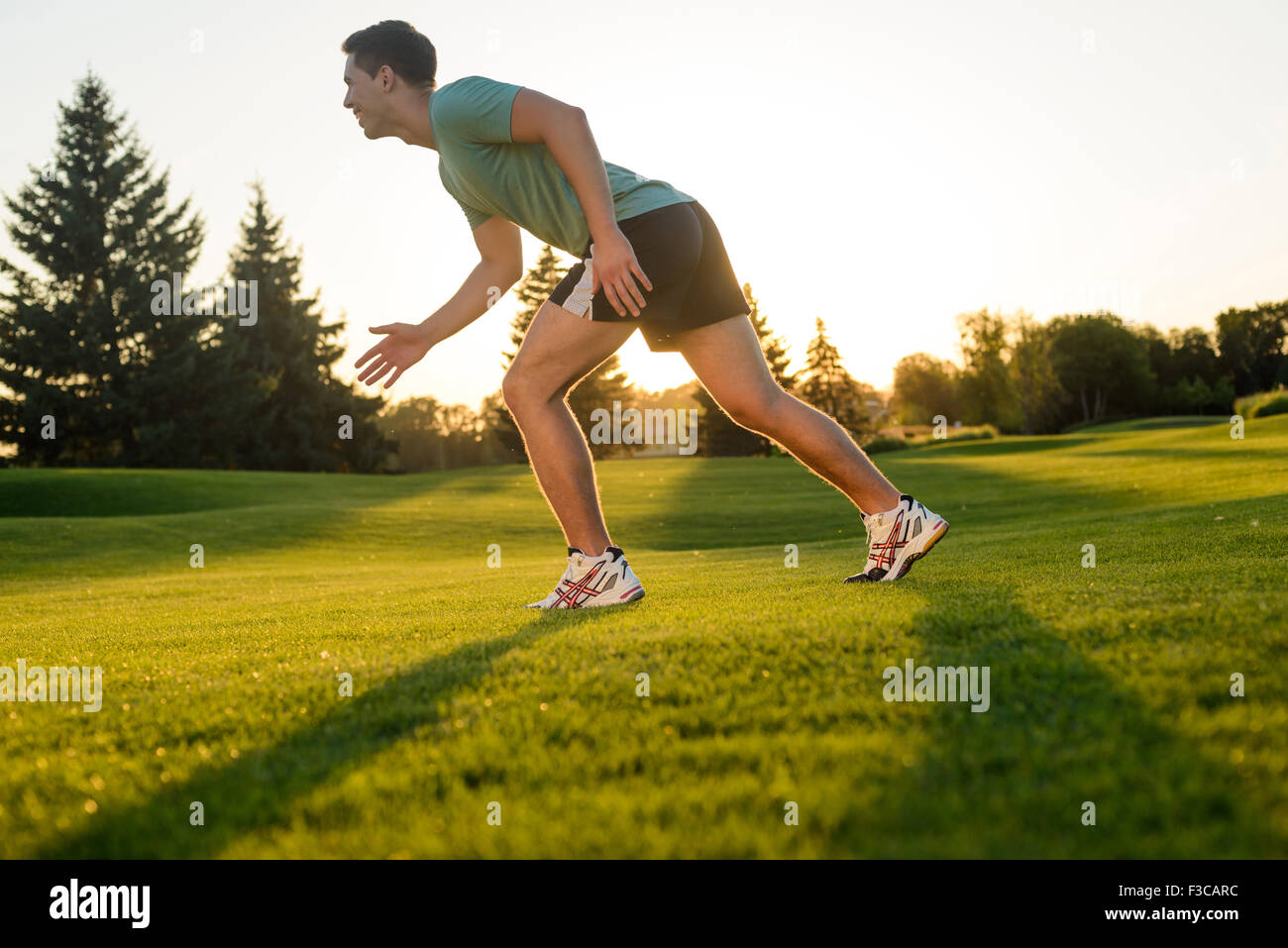 Guy run on sunset Stock Photo - Alamy