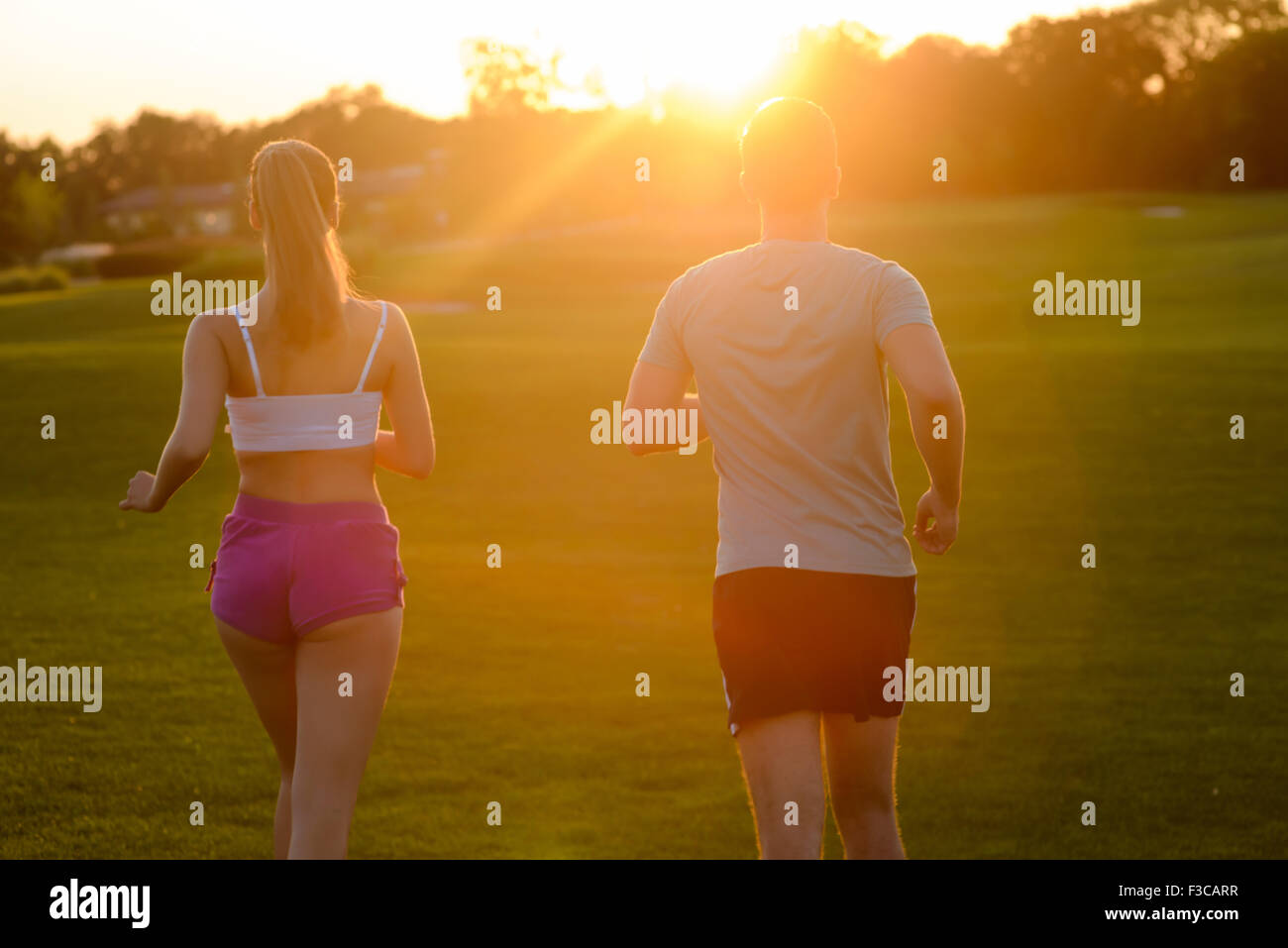 Guy and a girl running in the park Stock Photo - Alamy