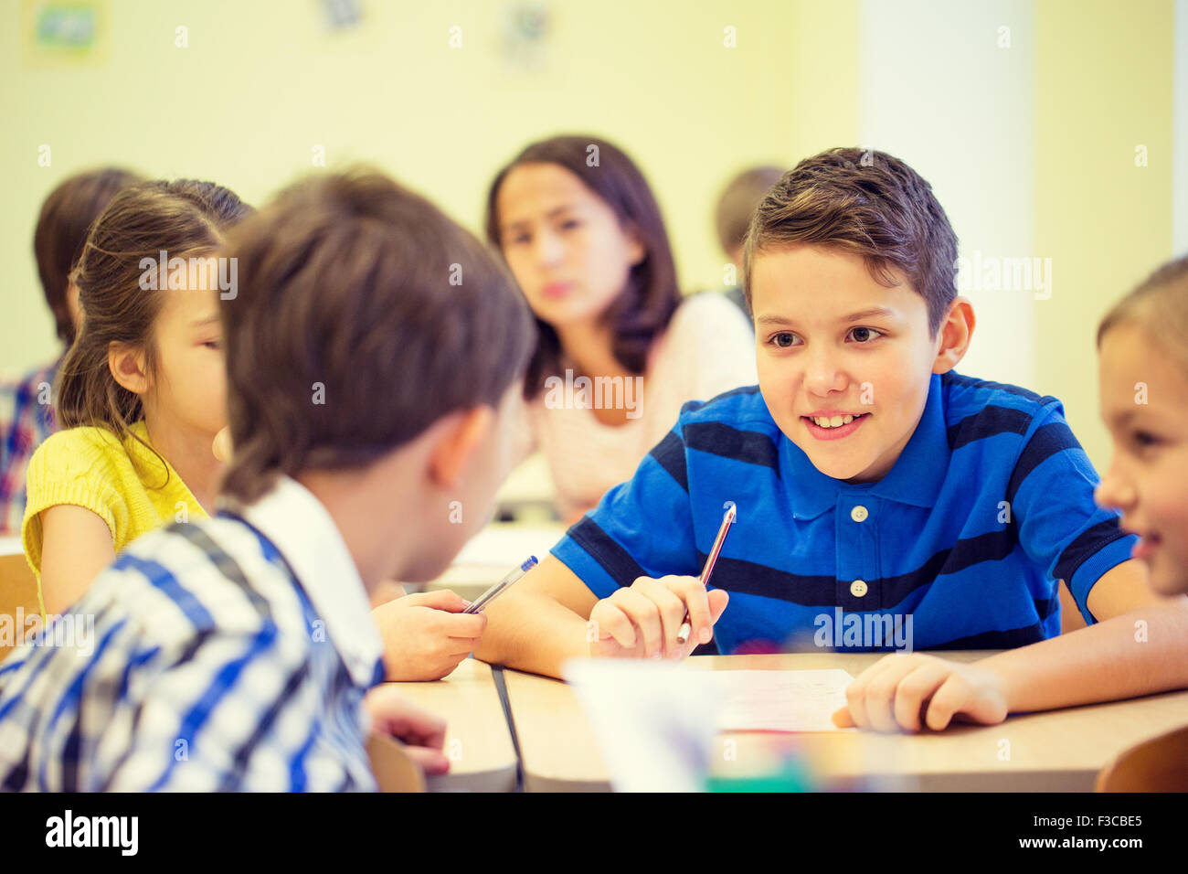 group of school kids writing test in classroom Stock Photo - Alamy