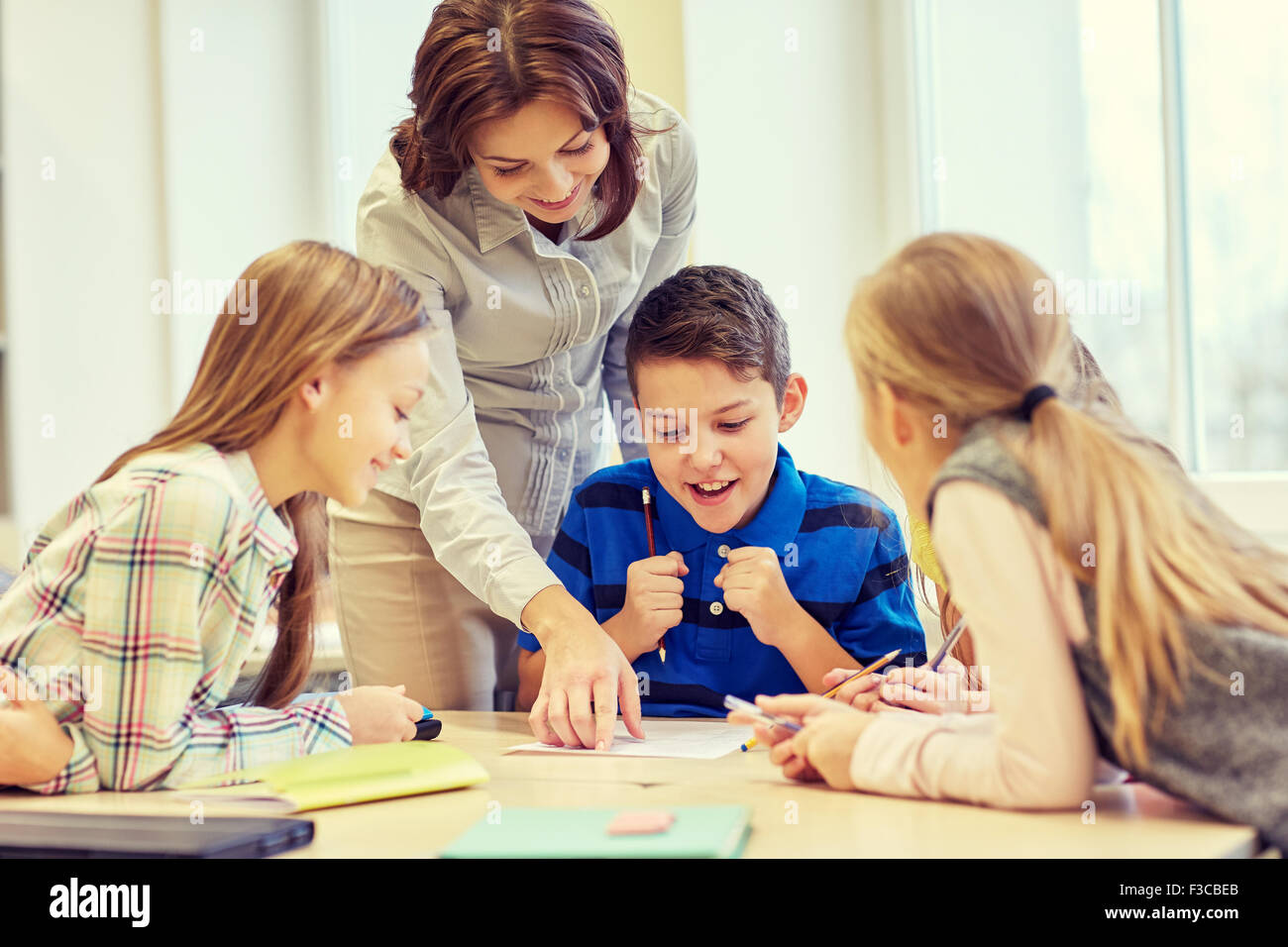 group of school kids writing test in classroom Stock Photo - Alamy