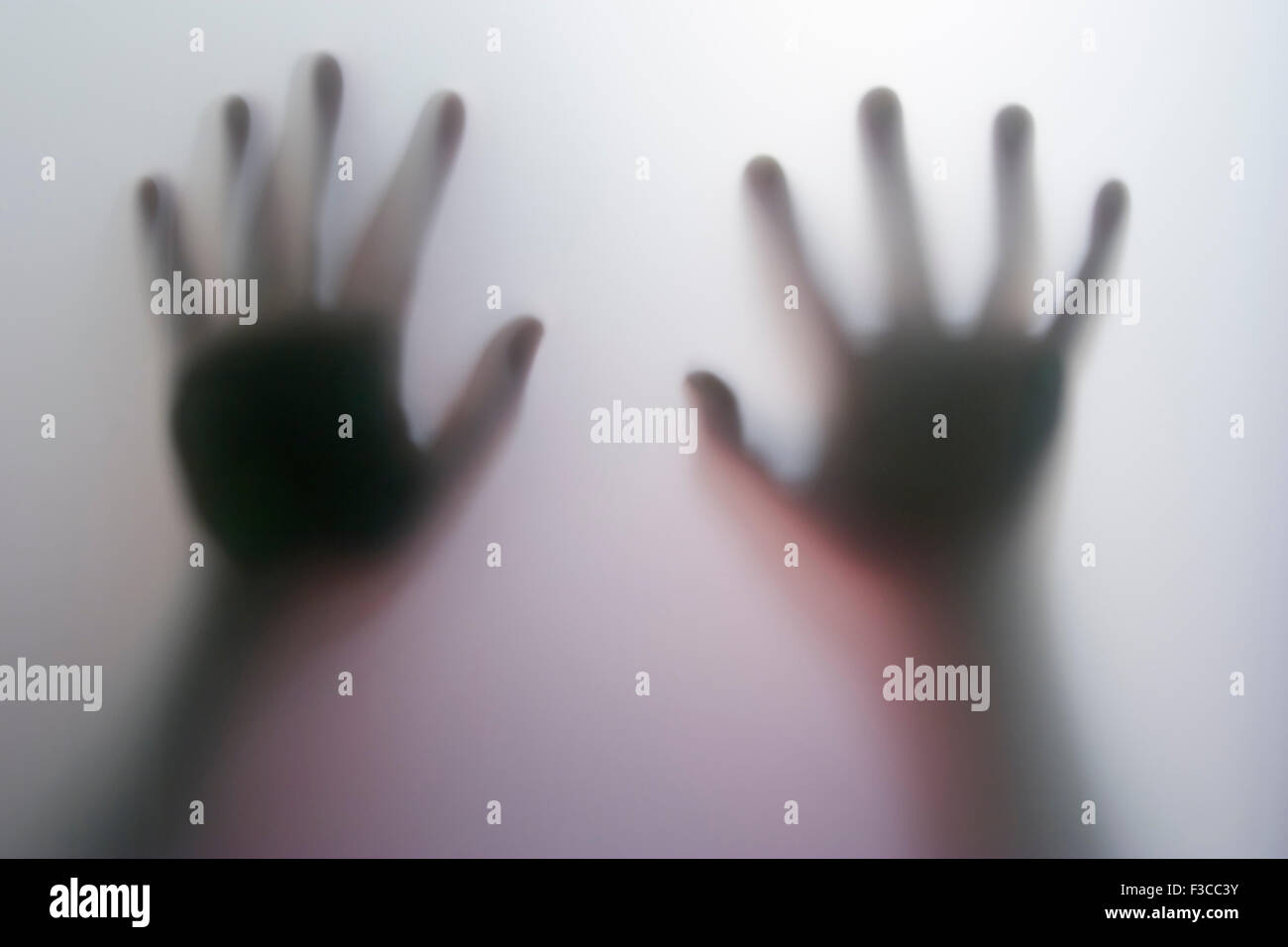 Victim, hands behind glass Stock Photo - Alamy