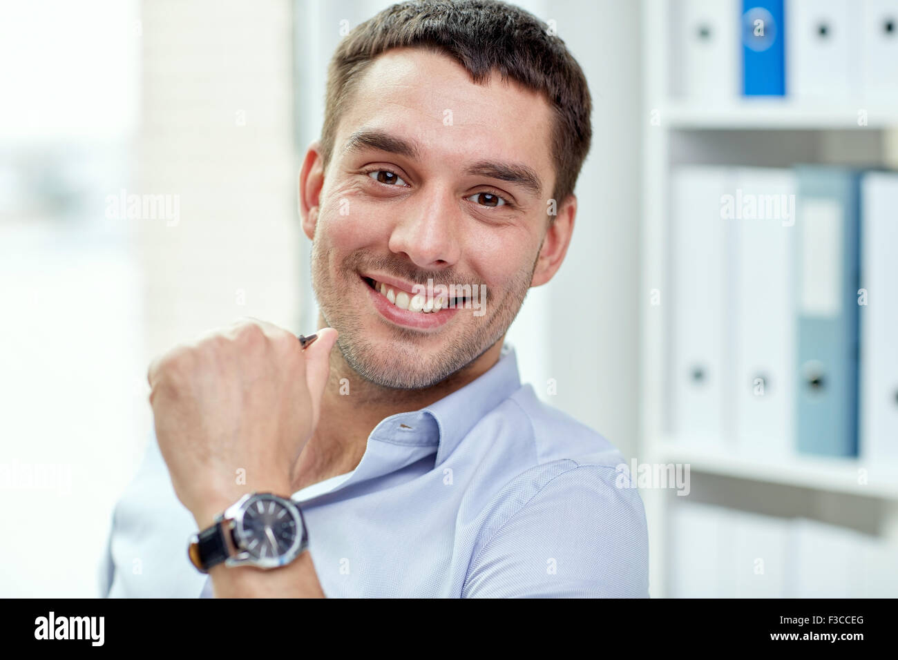 portrait of smiling businessman in office Stock Photo - Alamy