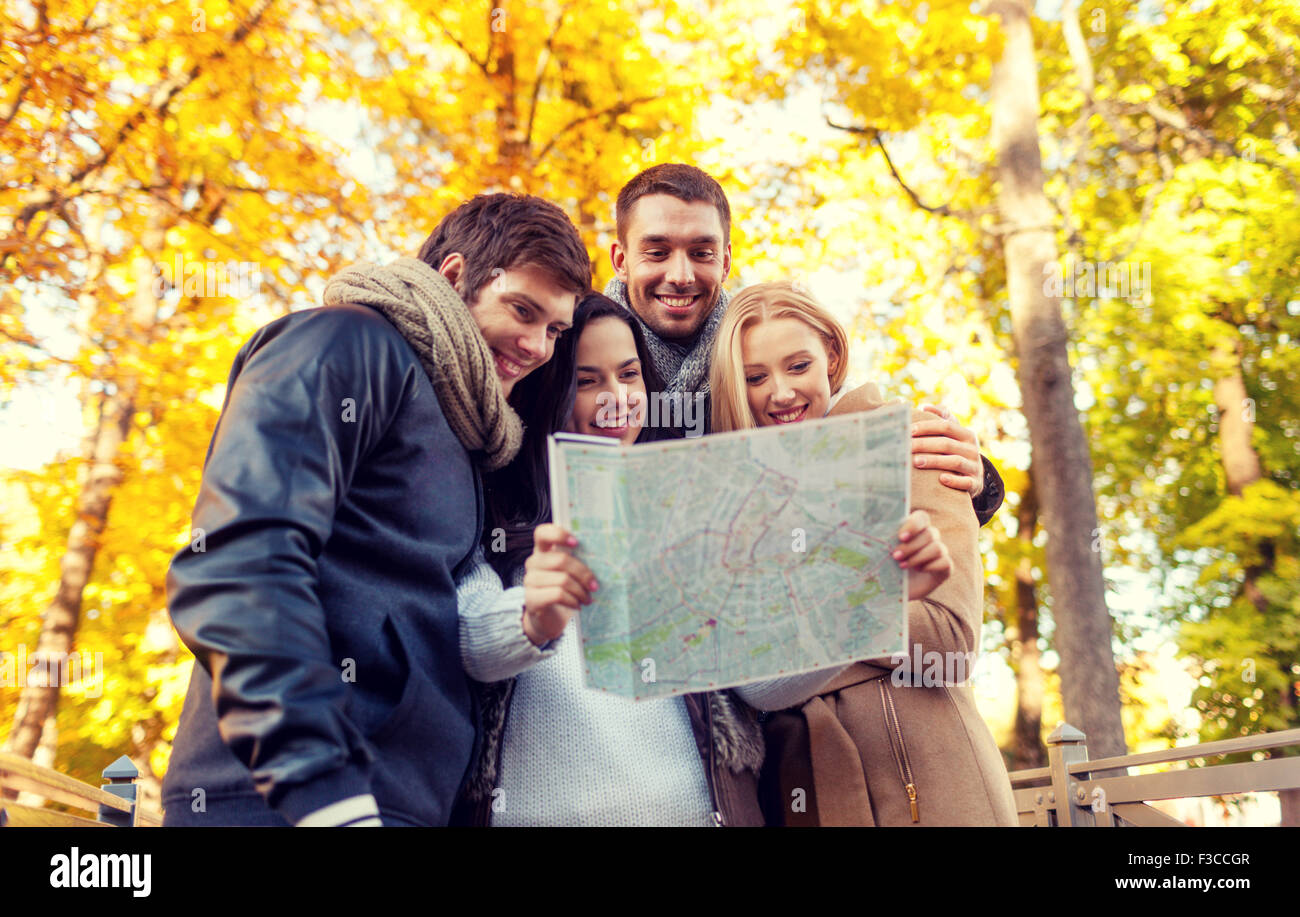 group of friends with map outdoors Stock Photo - Alamy