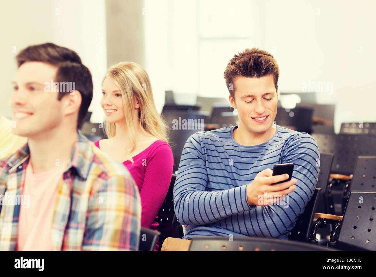 group of smiling students in lecture hall Stock Photo - Alamy