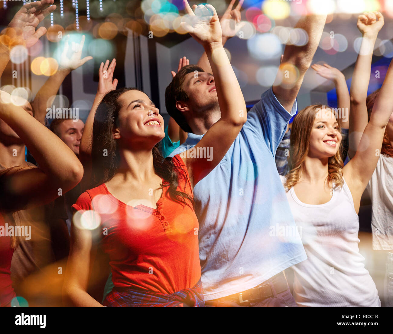 smiling friends at concert in club Stock Photo - Alamy