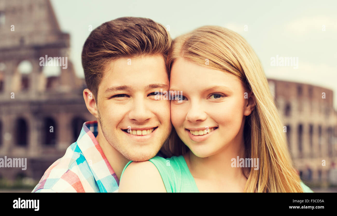 smiling couple over coliseum background Stock Photo - Alamy